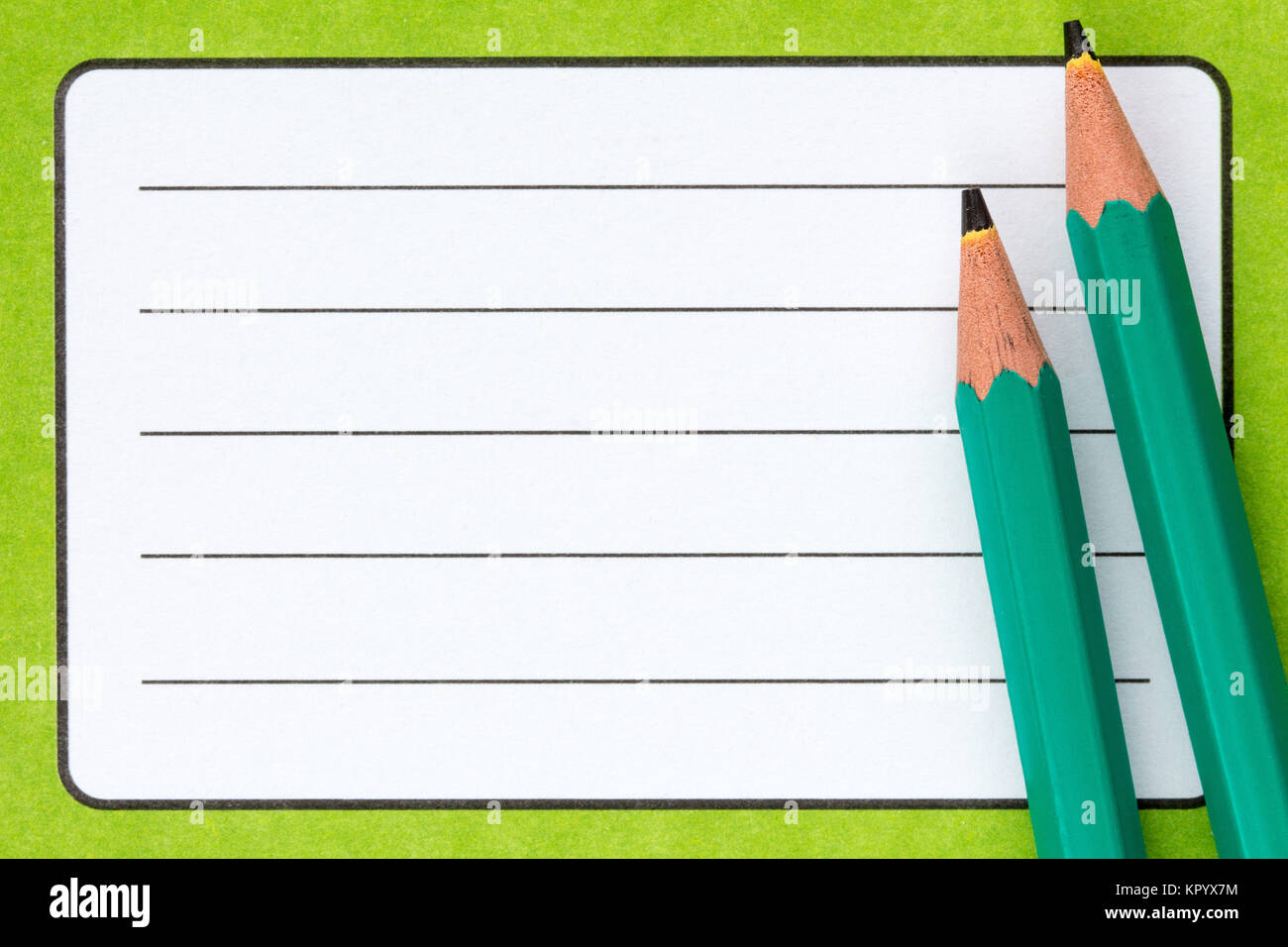 Exercise book name label and pencils Stock Photo - Alamy