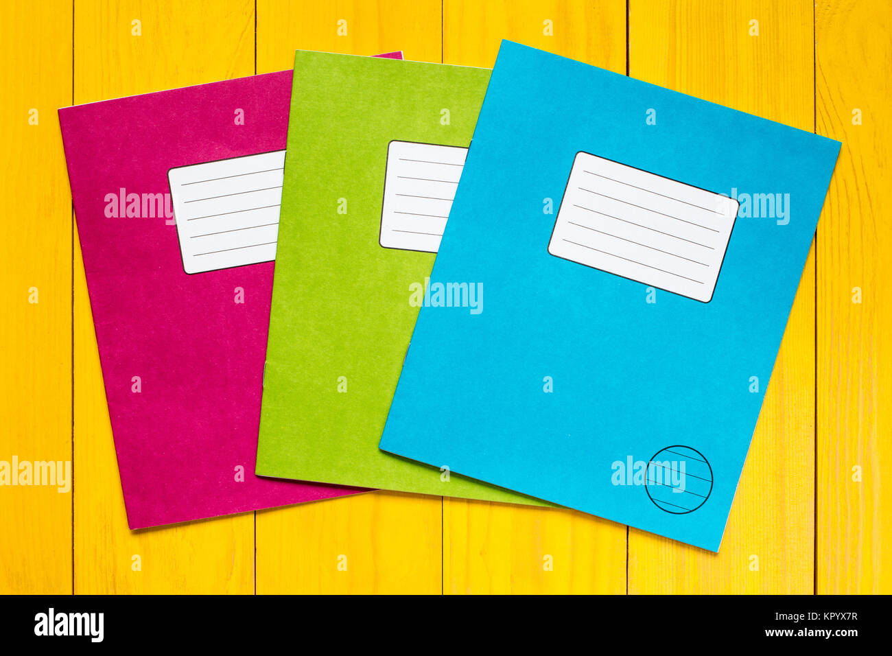 Exercise books on the yellow background Stock Photo - Alamy