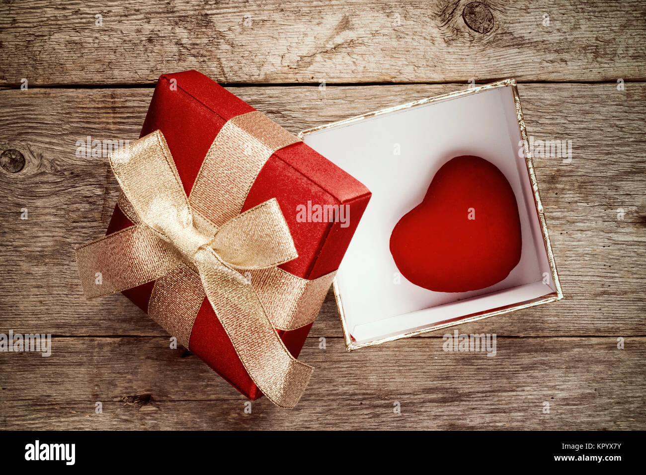 Gift box with a cute little heart inside Stock Photo - Alamy