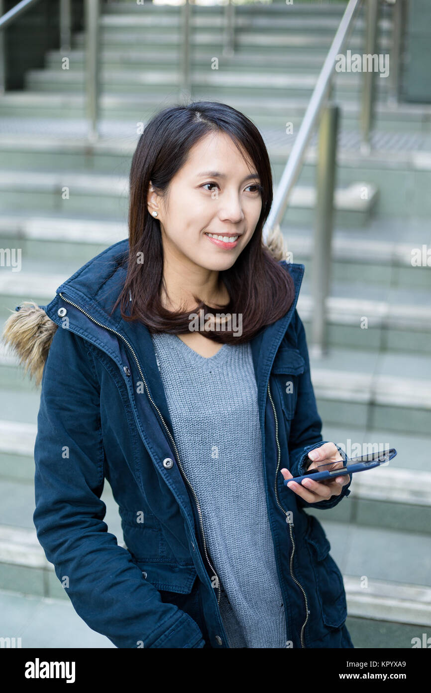 Woman hold with cellphone at outdoor Stock Photo - Alamy