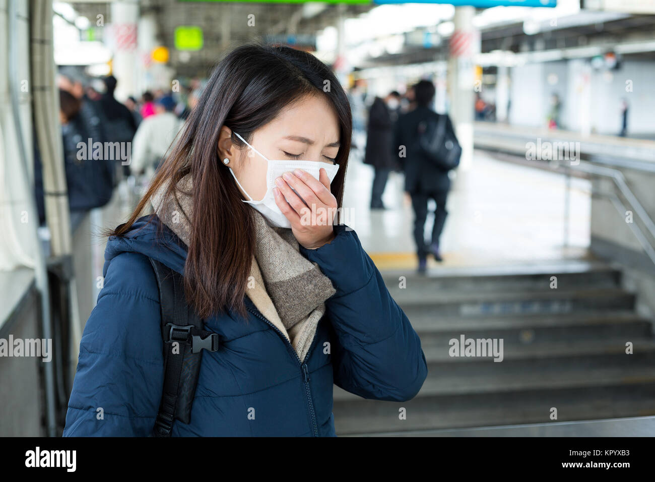 Woman wearing face mask in train station Stock Photo - Alamy