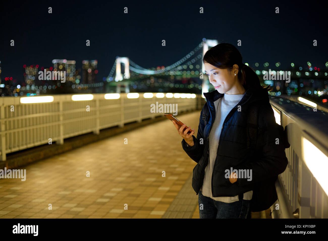 Woman use of mobile phone at night Stock Photo - Alamy