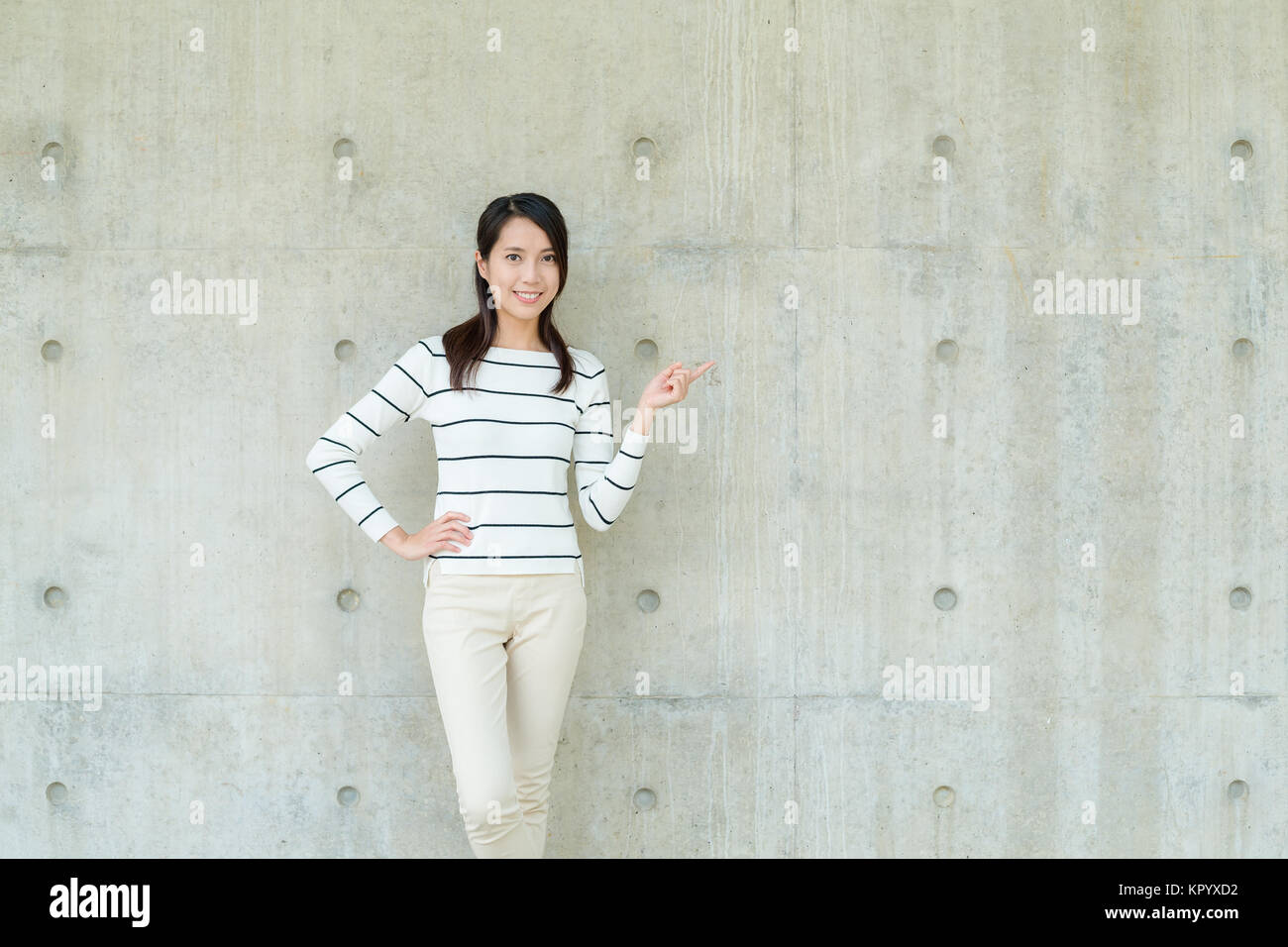 Woman showing finger point up Stock Photo - Alamy