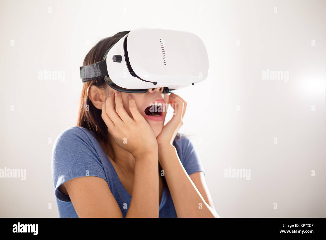 Scared Woman wearing VR device Stock Photo - Alamy