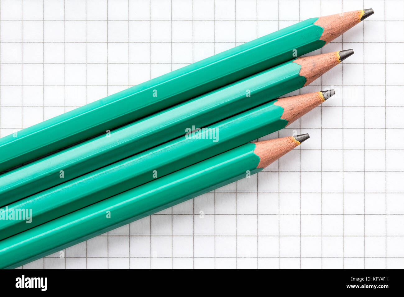 Four Pencils on Squared Paper Stock Photo - Alamy