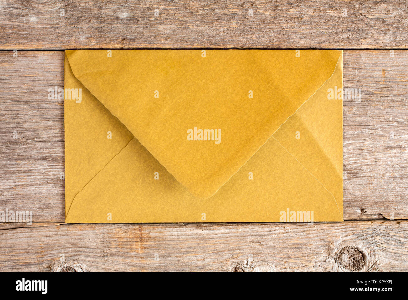 Golden envelope over wooden background Stock Photo - Alamy