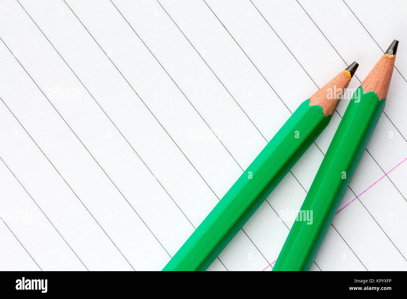 Green Pencils on Lined Paper Stock Photo - Alamy