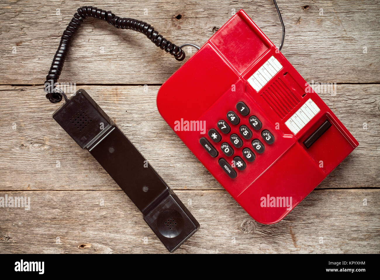 Vintage red phone on rustic boards Stock Photo - Alamy