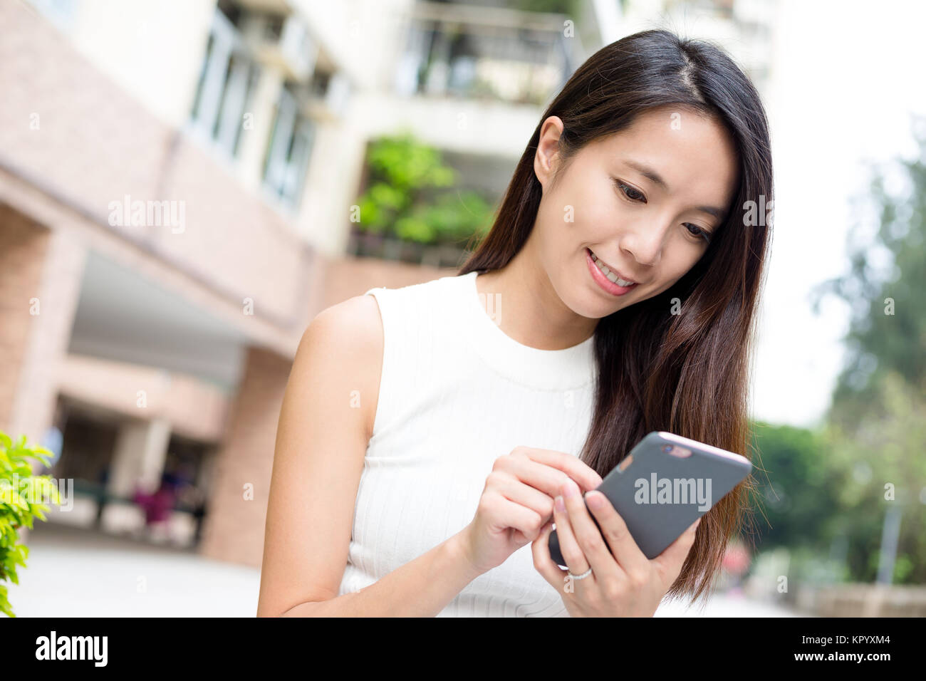Woman texting message on mobile phone Stock Photo - Alamy