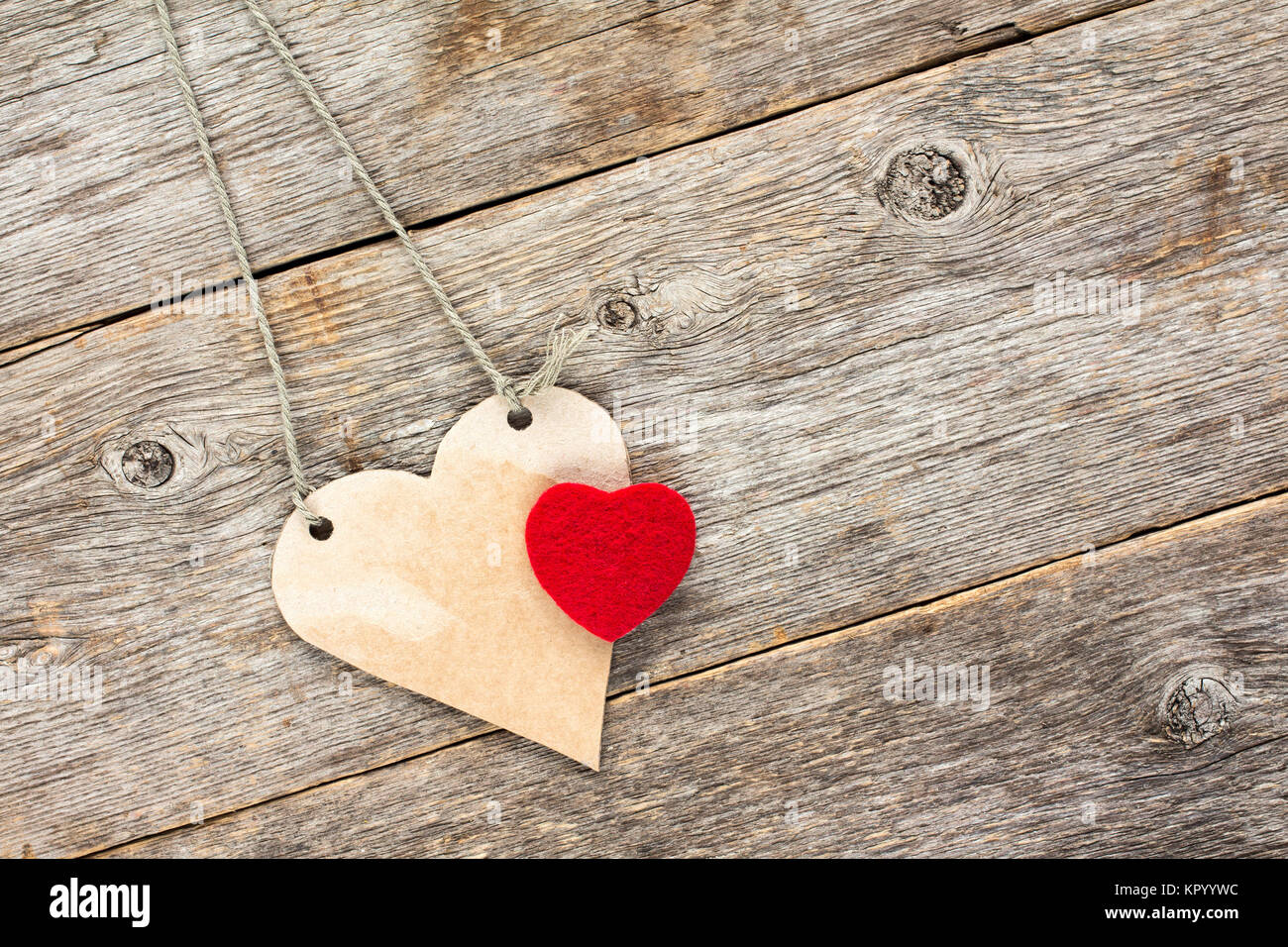 Love hearts hanging on wooden background Stock Photo - Alamy