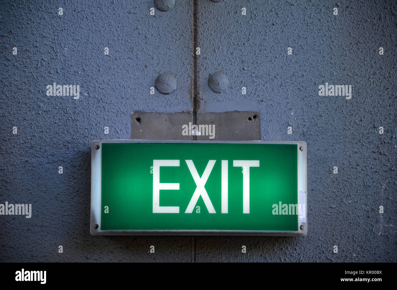 Exit sign points the way out Stock Photo - Alamy