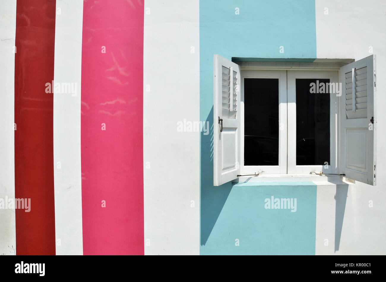 Windows on multi color wall Stock Photo - Alamy