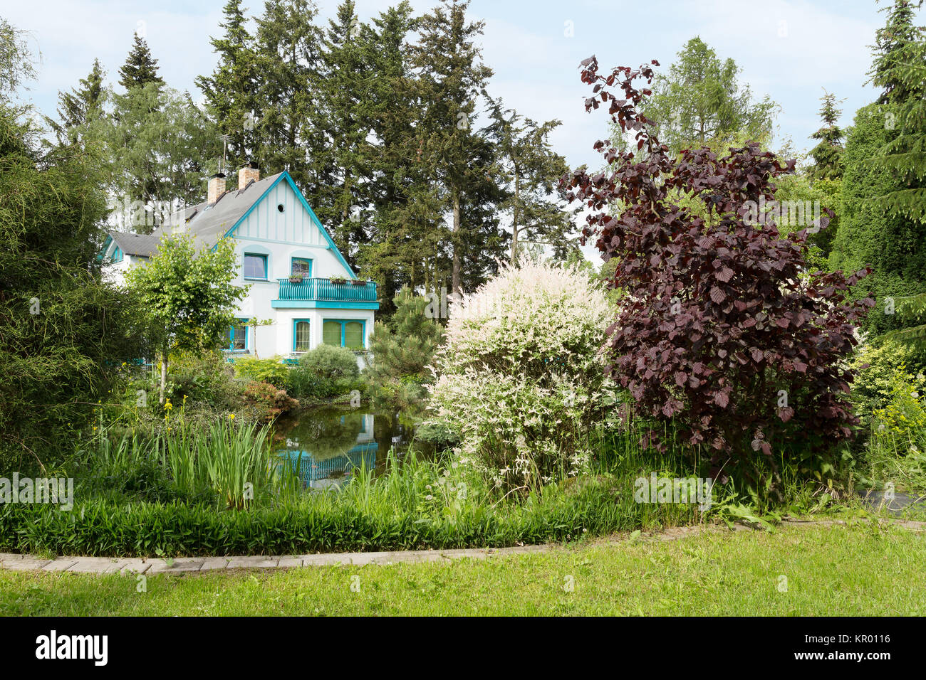 Beautiful house in spring garden Stock Photo - Alamy