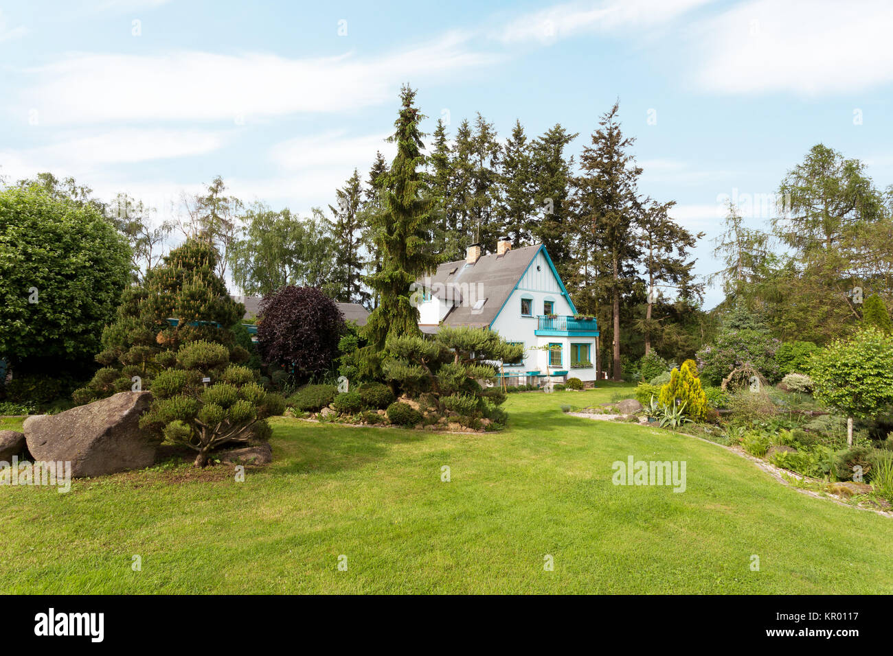 Beautiful house in spring garden Stock Photo - Alamy