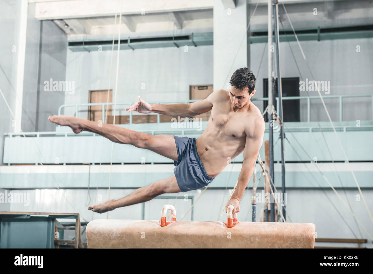The sportsman during difficult exercise, sports gymnastics Stock Photo ...