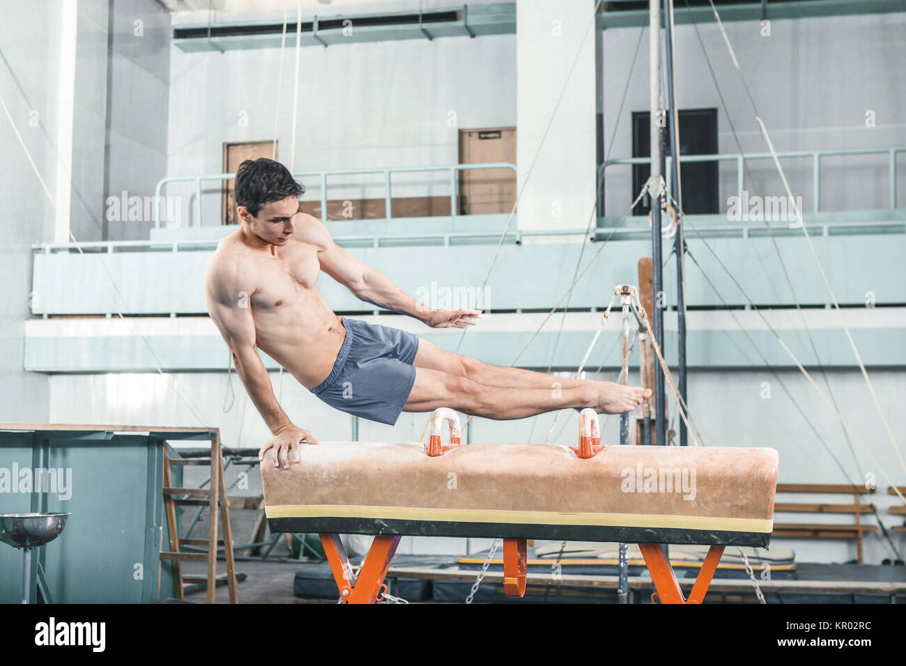 The sportsman during difficult exercise, sports gymnastics Stock Photo ...