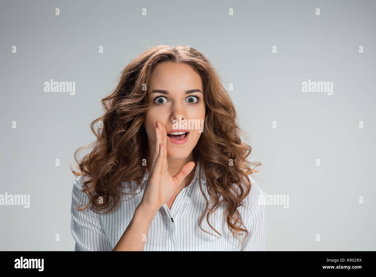 Portrait of young woman with shocked facial expression Stock Photo - Alamy