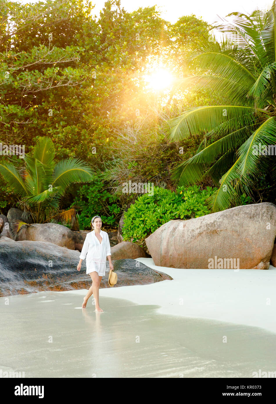 A beautiful woman walking on the beach Stock Photo - Alamy