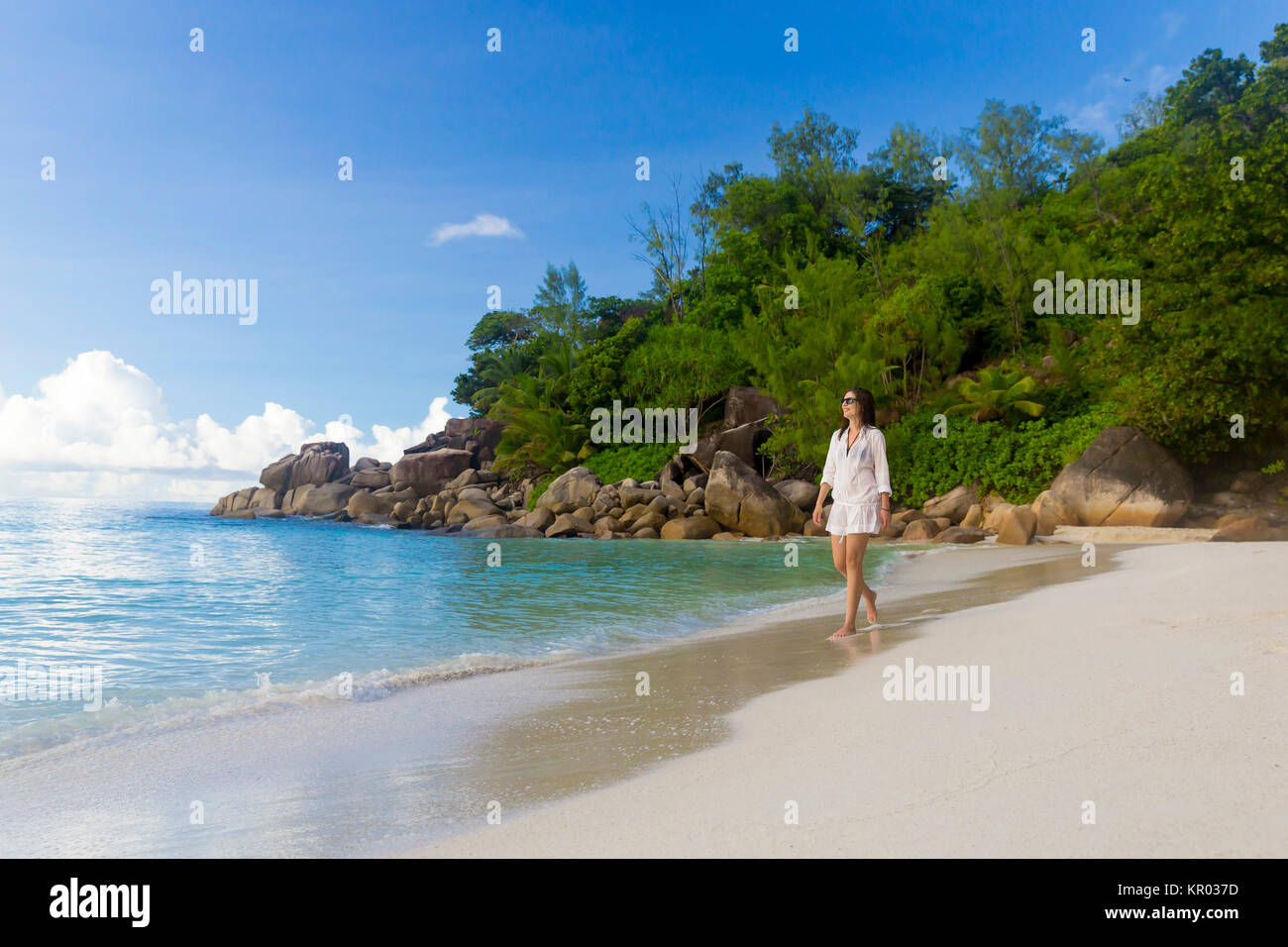 A beautiful woman walking on the beach Stock Photo - Alamy