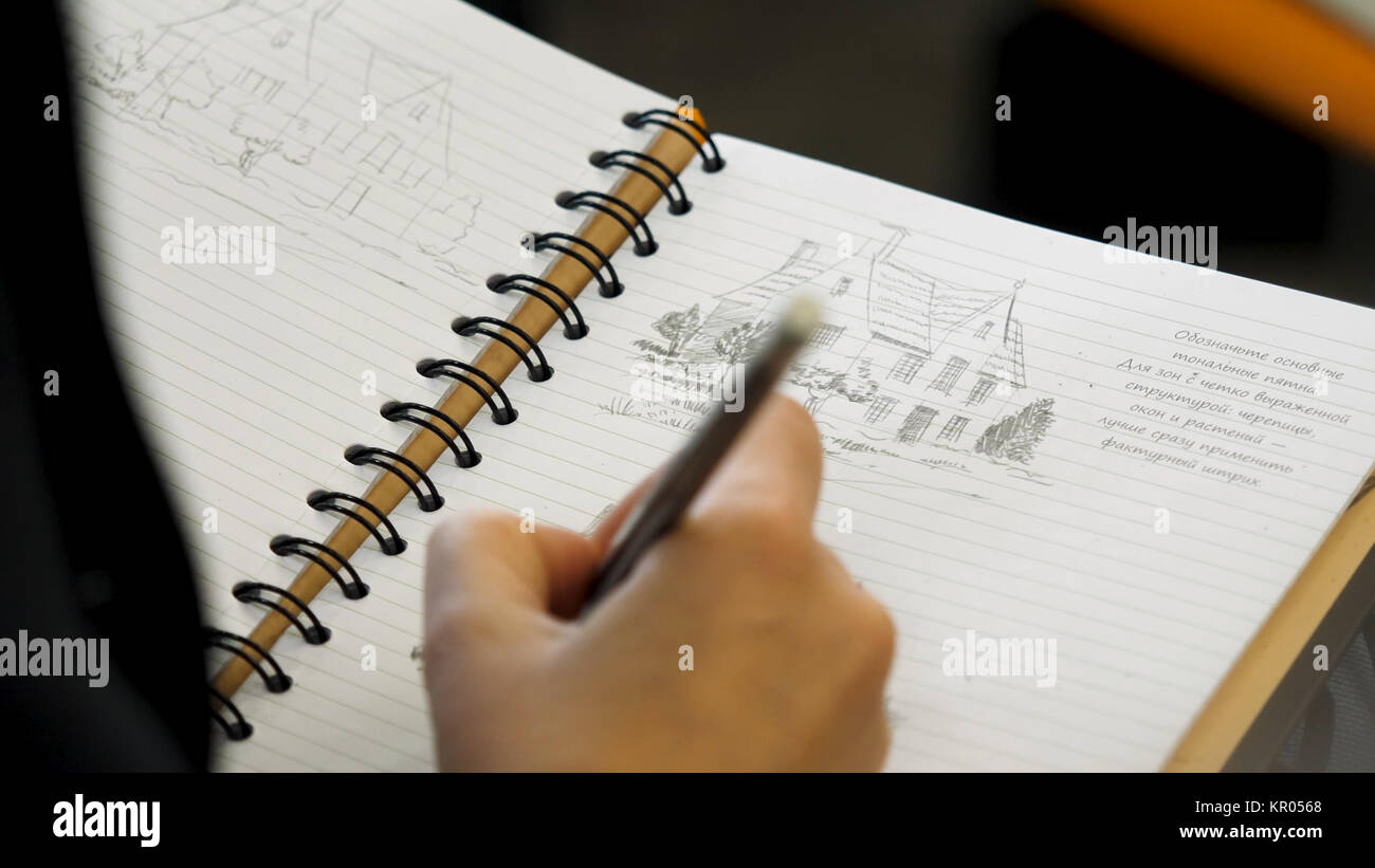 Male hands drawing pictures in notebook, close up Stock Photo - Alamy