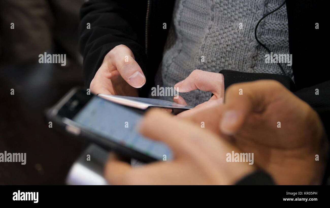 Close up of hands with cellphone and diary. Businessmen using to phone ...