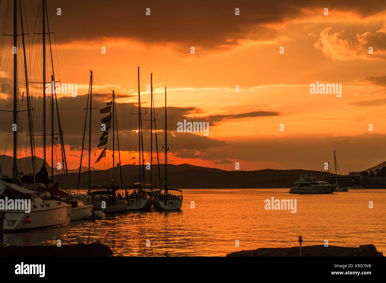 Sunset in Poros island port with the sailing boats in Greece Stock ...