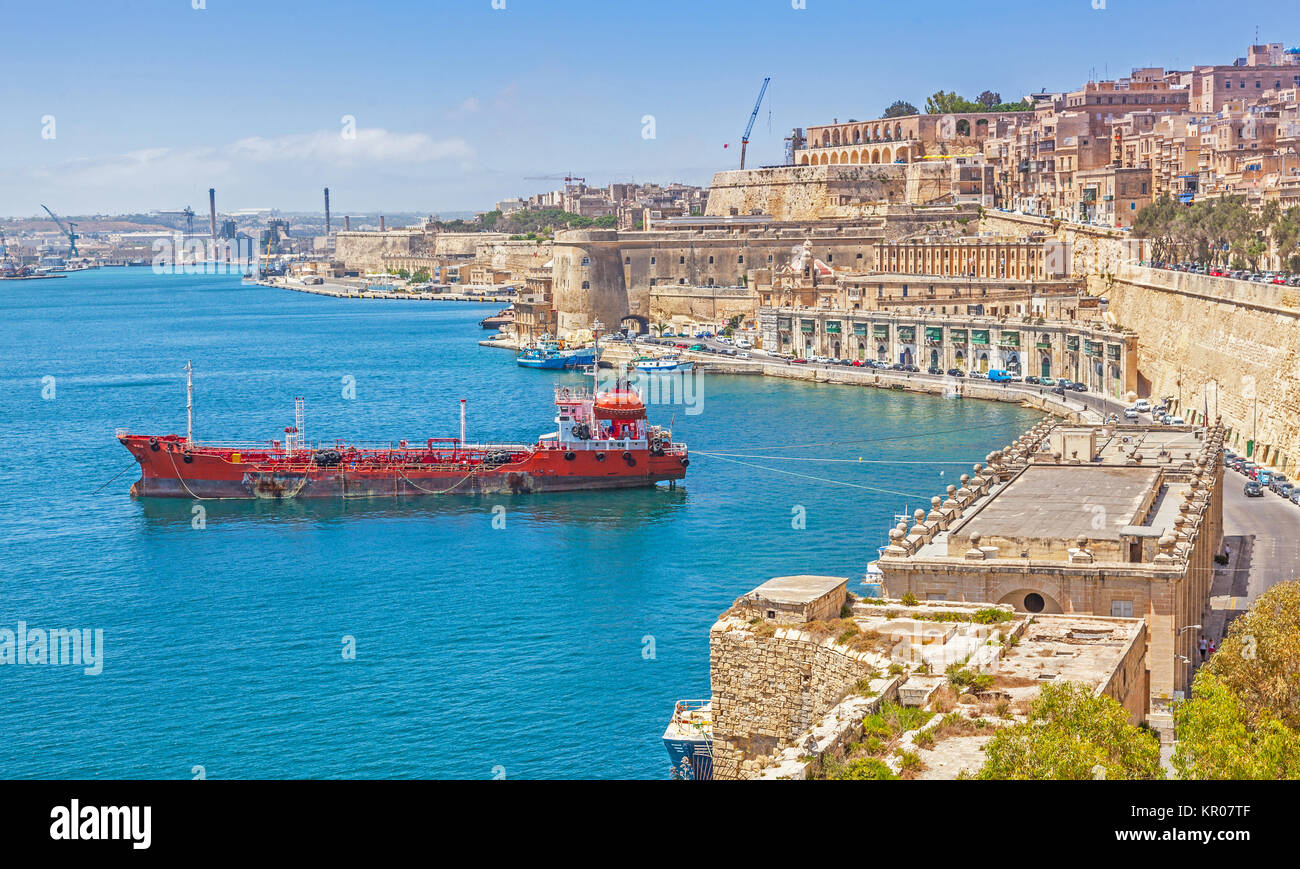 A red ship in Grand Harbour of the old harbor city of Valletta in Malta ...