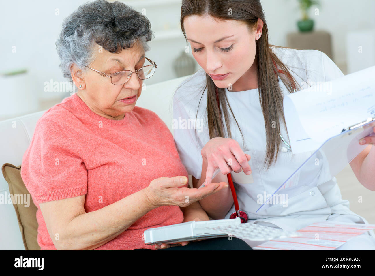 Doctor helping patient with medication Stock Photo - Alamy