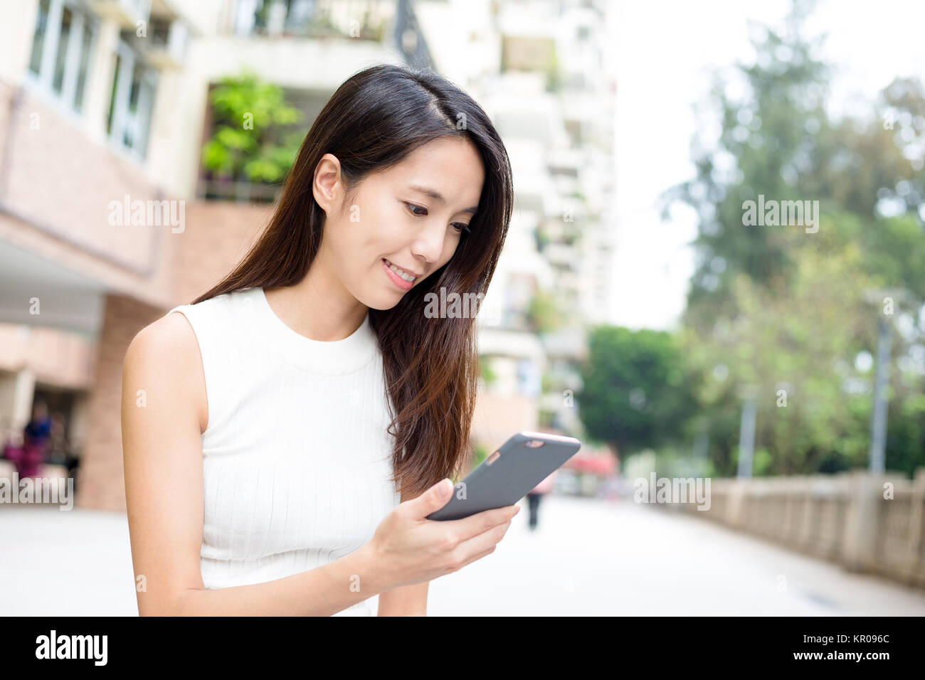 Young Woman browsing internet on mobile phone Stock Photo - Alamy