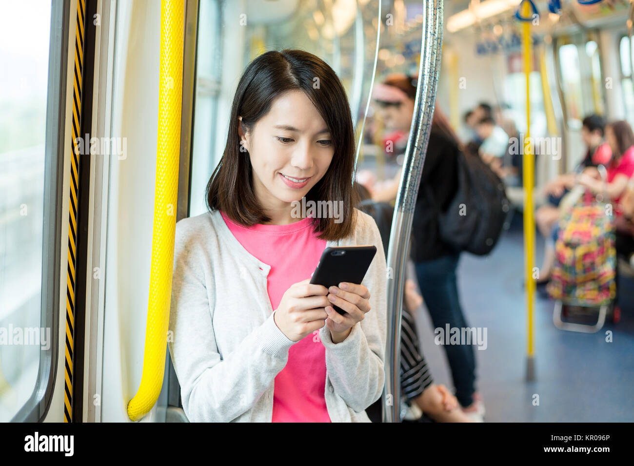 Woman use of mobile phone in train compartment Stock Photo - Alamy