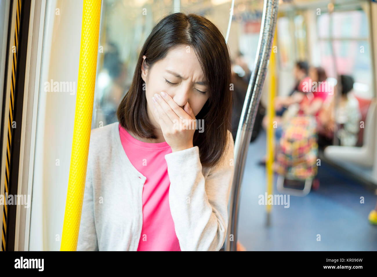 Woman feeling sick inside train compartment Stock Photo - Alamy