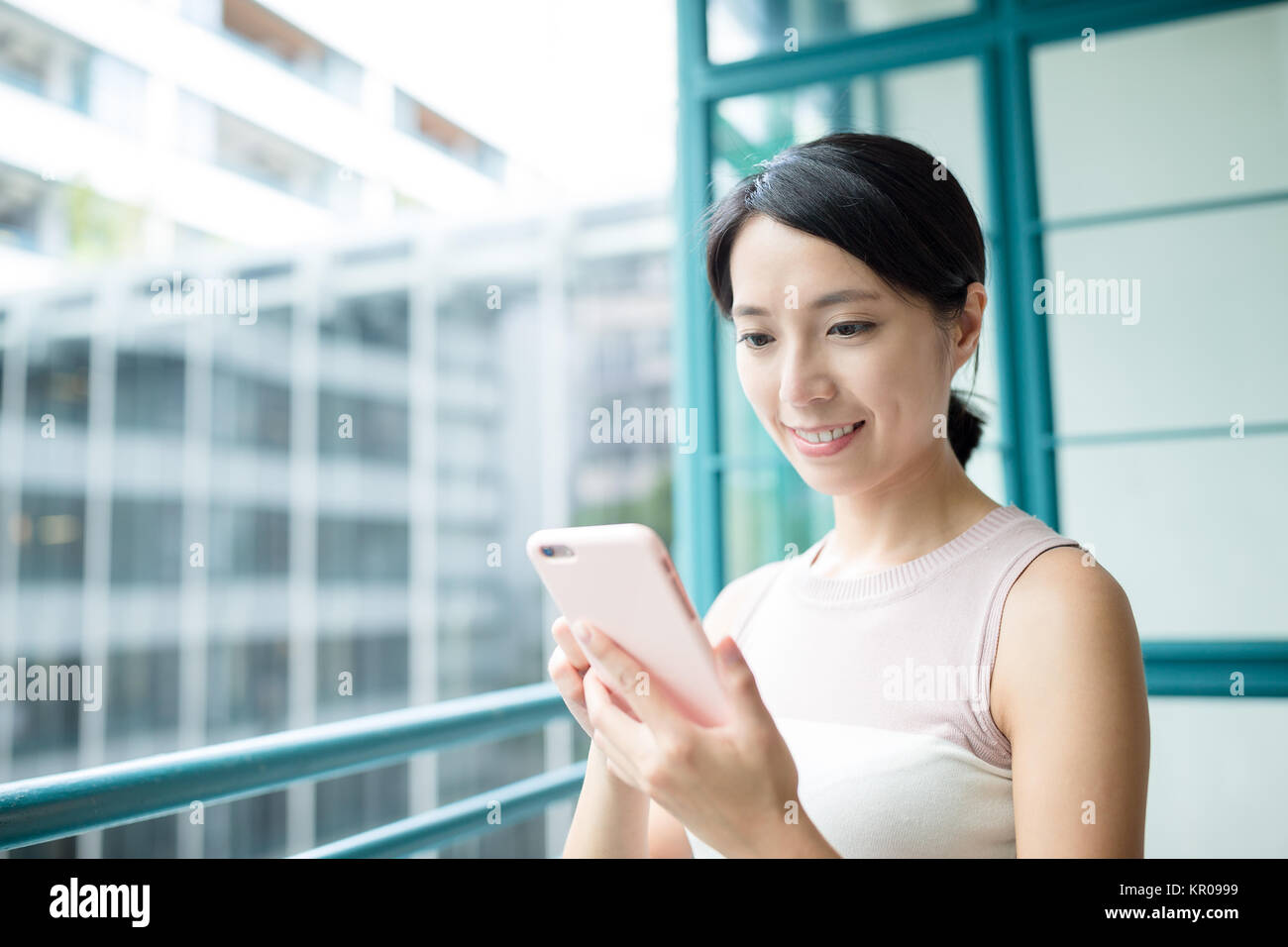 Woman looking at mobile phone Stock Photo - Alamy