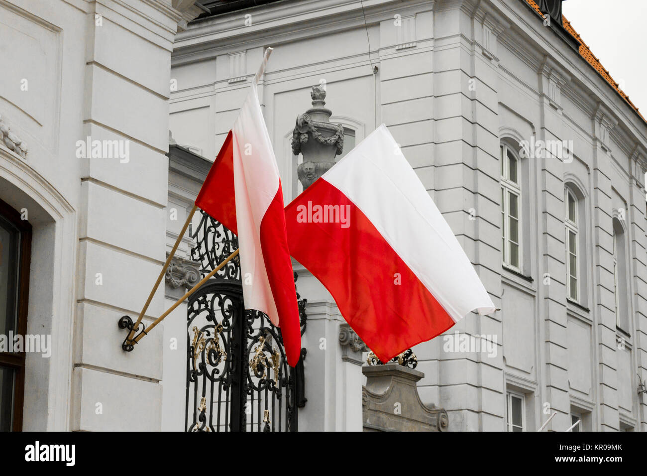 Waving flags of Poland in the wall of a palace in Warsaw Stock Photo ...