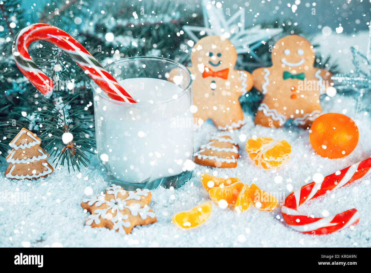 Christmas gingerbread and milk with decorations, snow, christmas tree ...