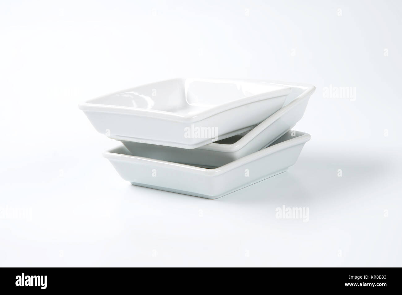 Ceramic rectangle white deep plates Stock Photo - Alamy