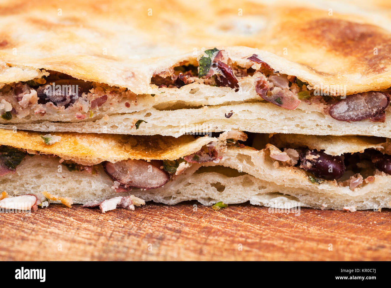 cutting bean filled pie (Lobiani) close up Stock Photo - Alamy