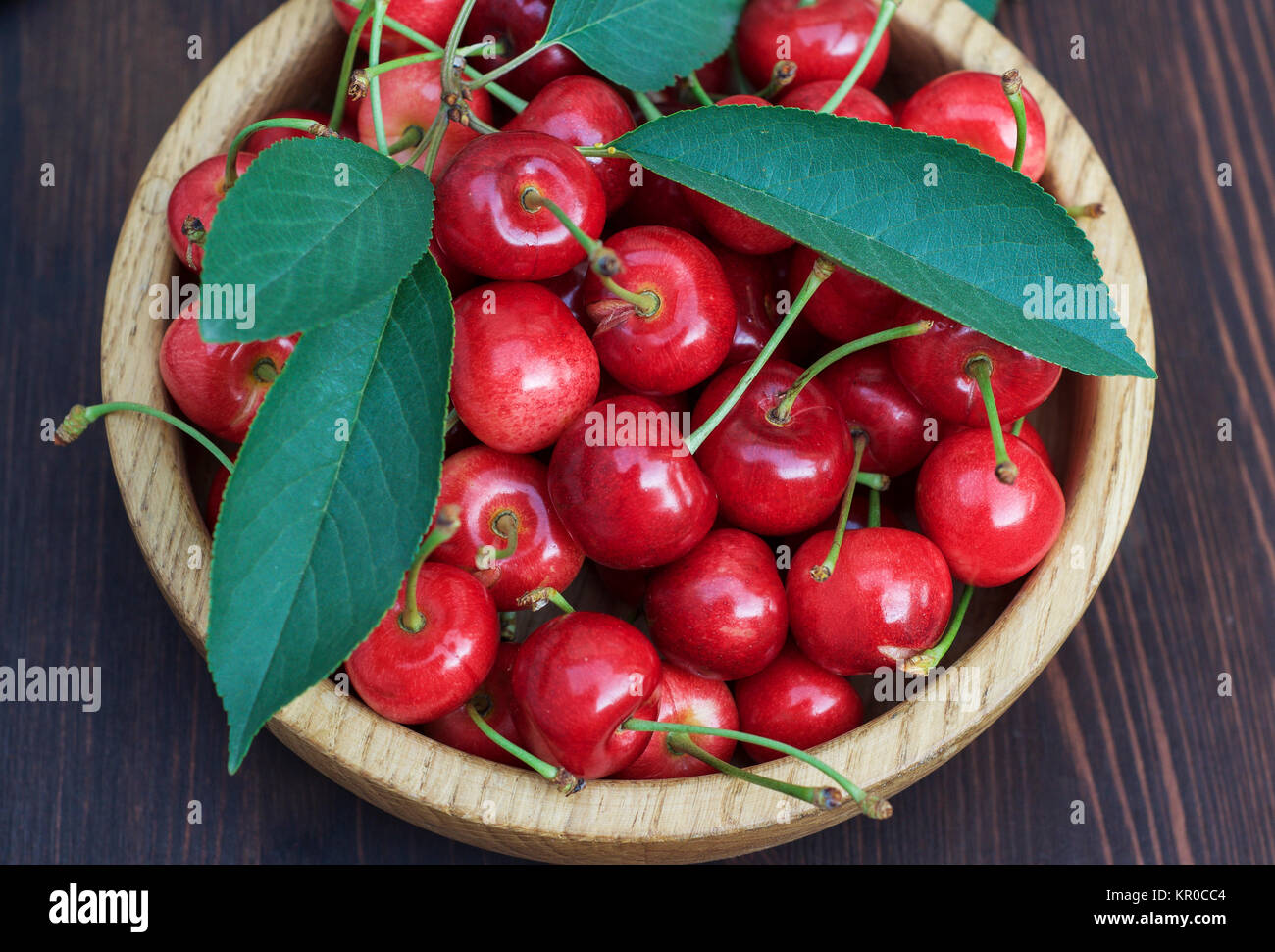 Cherry in wooden plate Stock Photo - Alamy