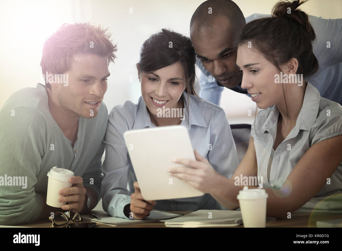 Young business people meeting around table Stock Photo - Alamy