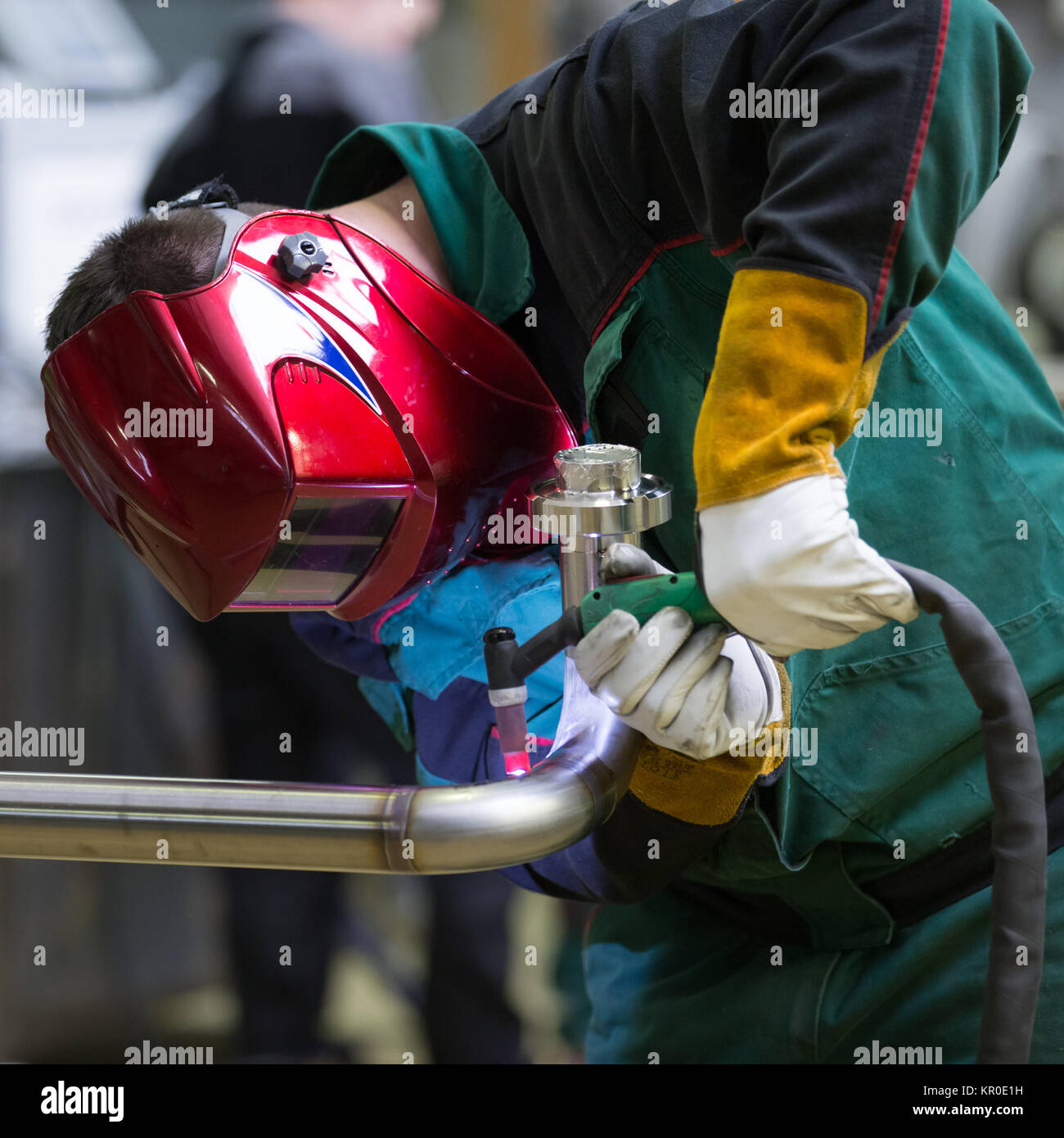 Industrial worker welding in metal factory Stock Photo - Alamy