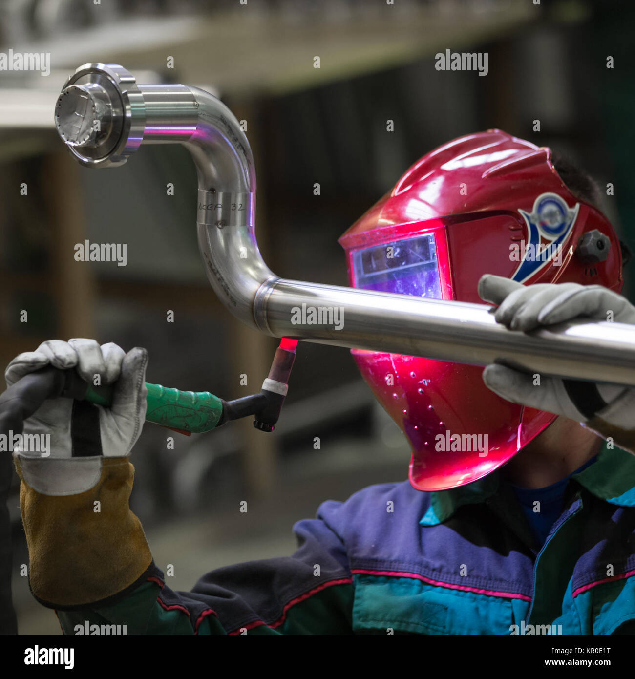 Industrial worker welding in metal factory Stock Photo - Alamy
