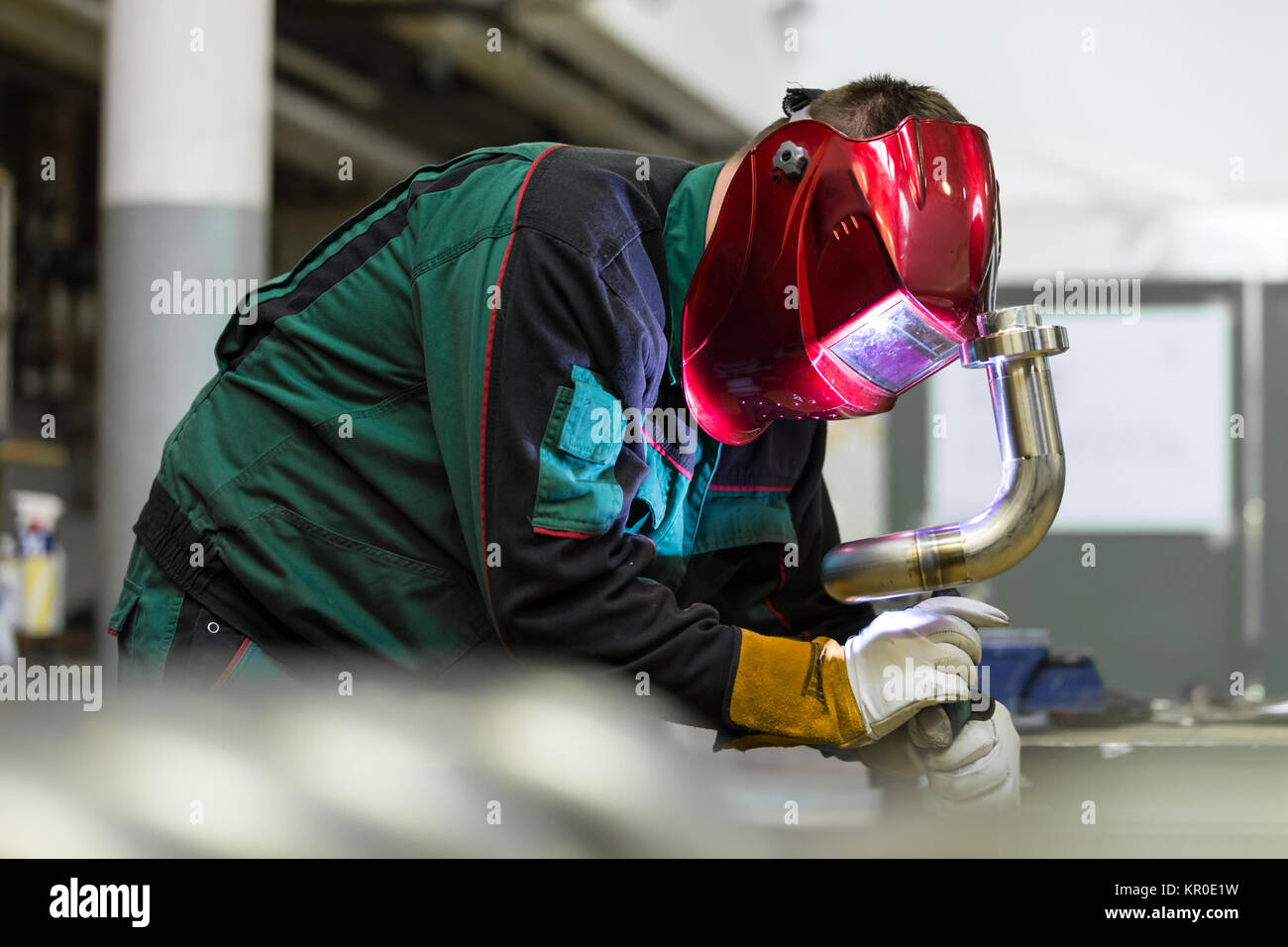Industrial worker welding in metal factory Stock Photo - Alamy
