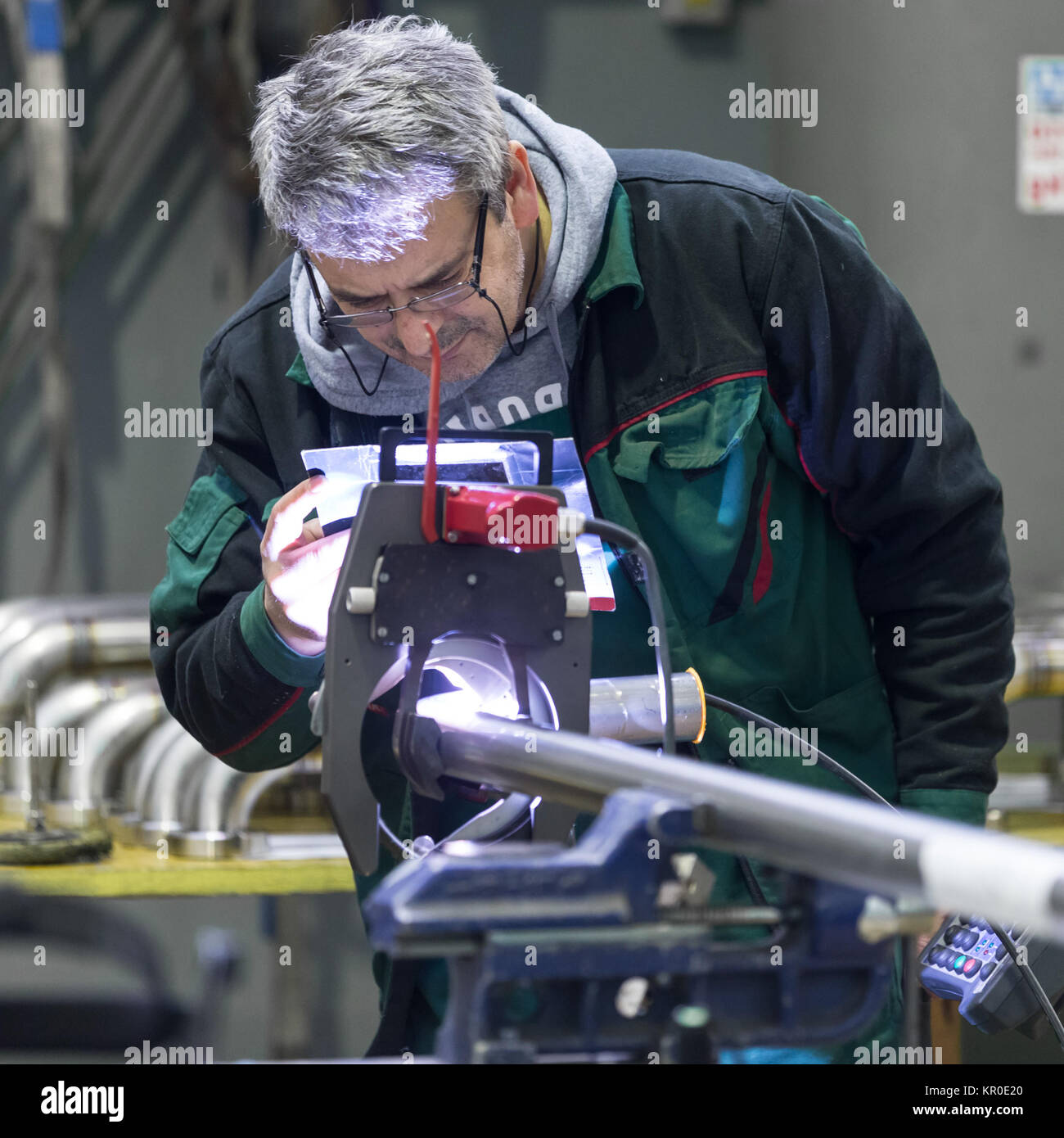 Industrial worker setting orbital welding machine Stock Photo - Alamy