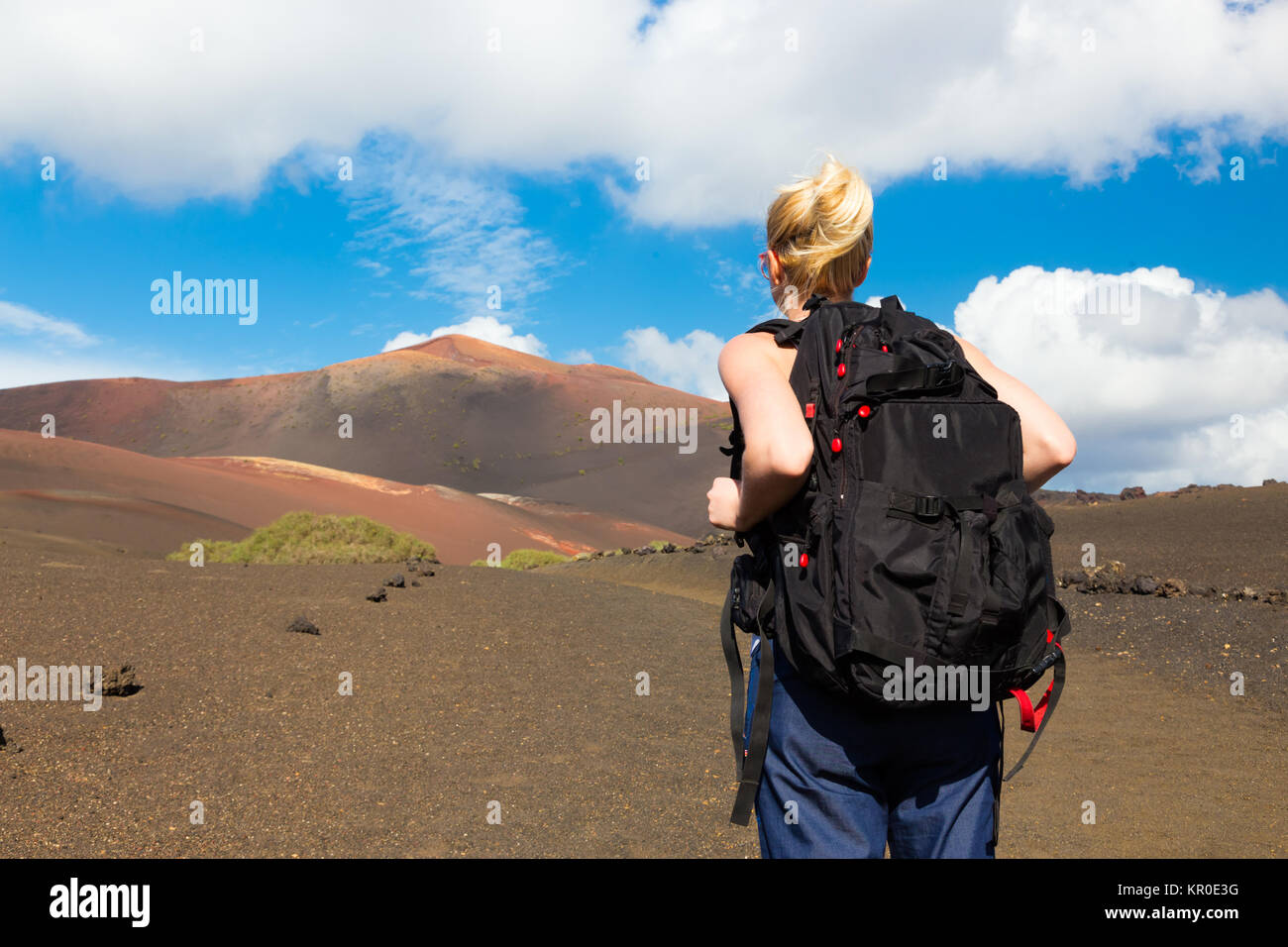 Woman tracking to top of mountain Stock Photo - Alamy