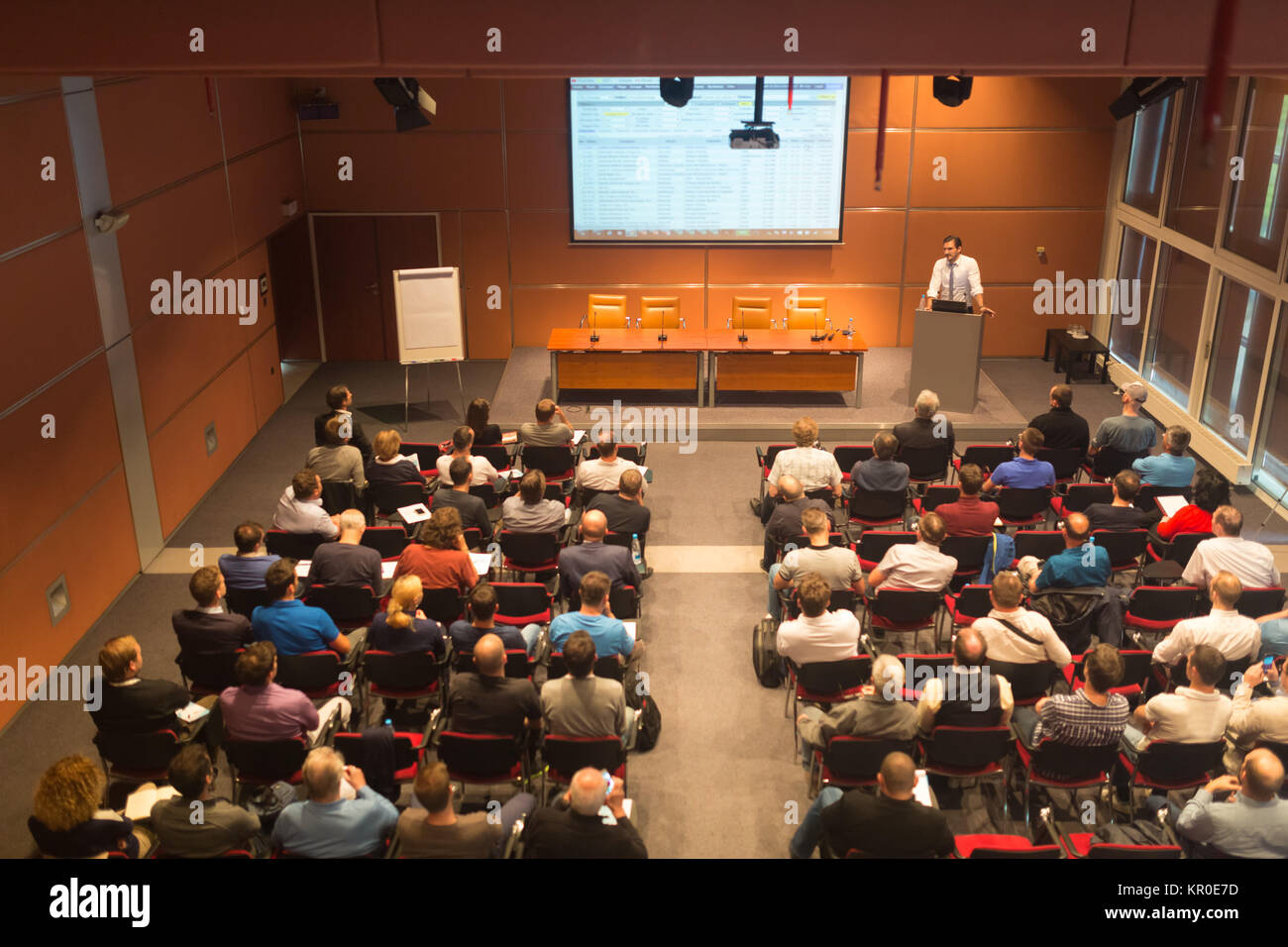 Business speaker giving a talk in conference hall Stock Photo - Alamy