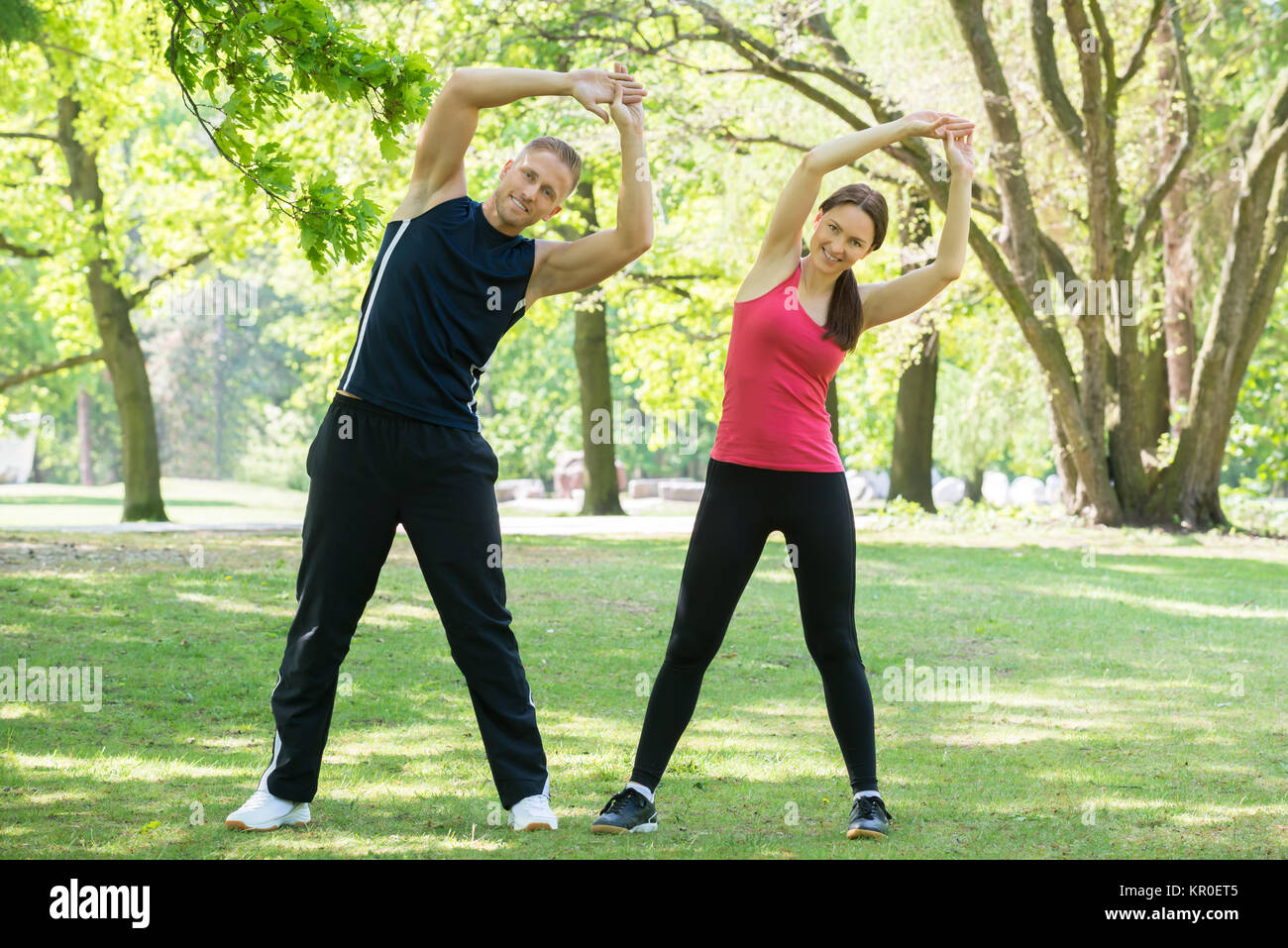 Young Couple Exercising Stock Photo - Alamy