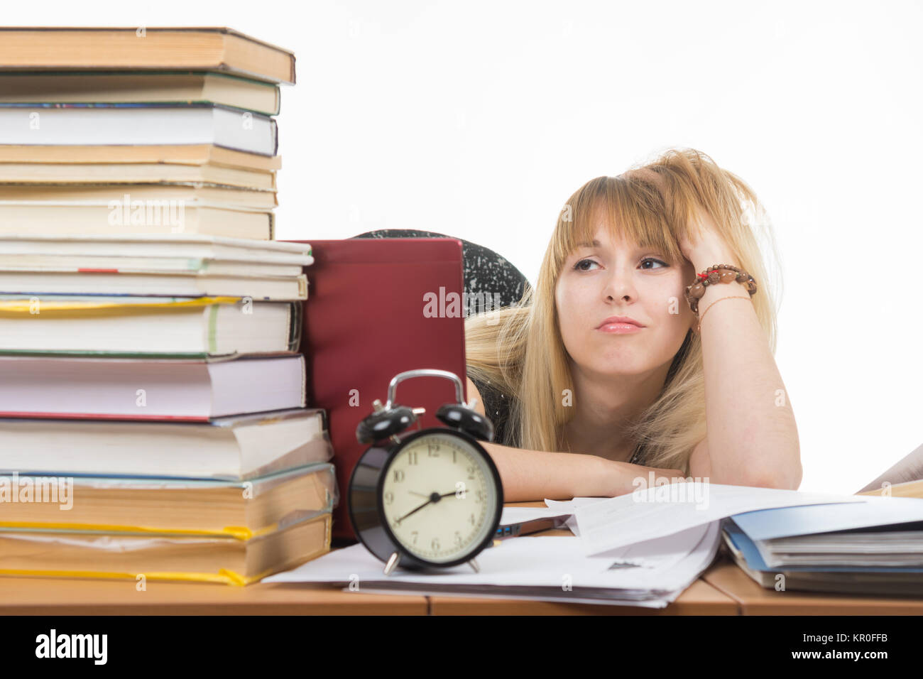 Student sad looking at a stack of books Stock Photo - Alamy