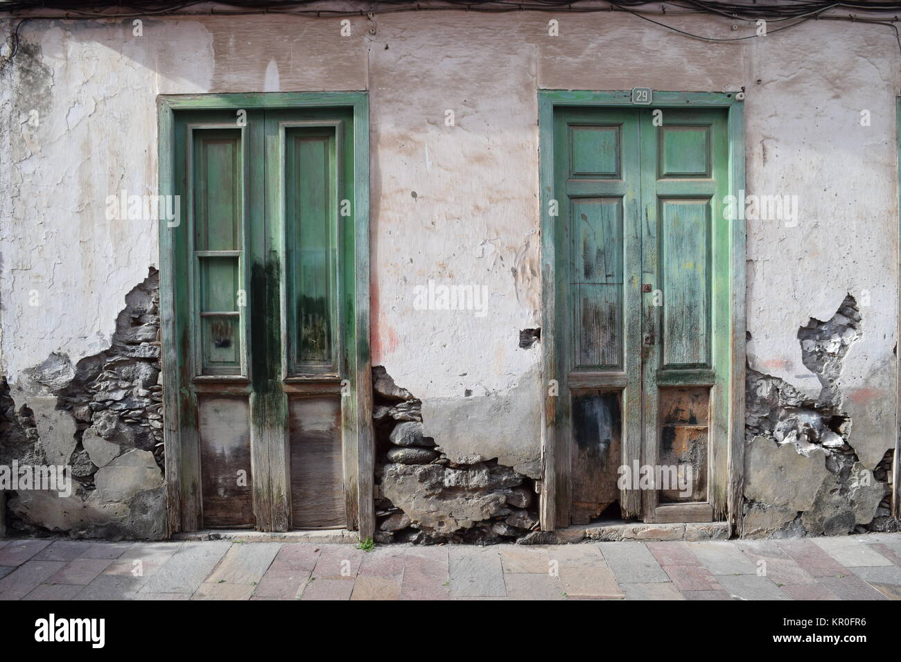 broken and weathered doors in a ruin with exposed-brick walls Stock ...