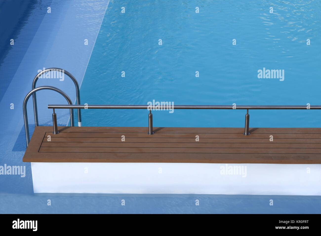 swimming pool with entry on the side and wooden bench by the pool Stock ...