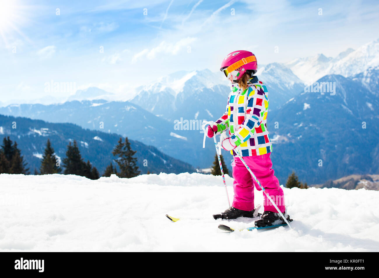 Child skiing in mountains. Active toddler kid with safety helmet ...