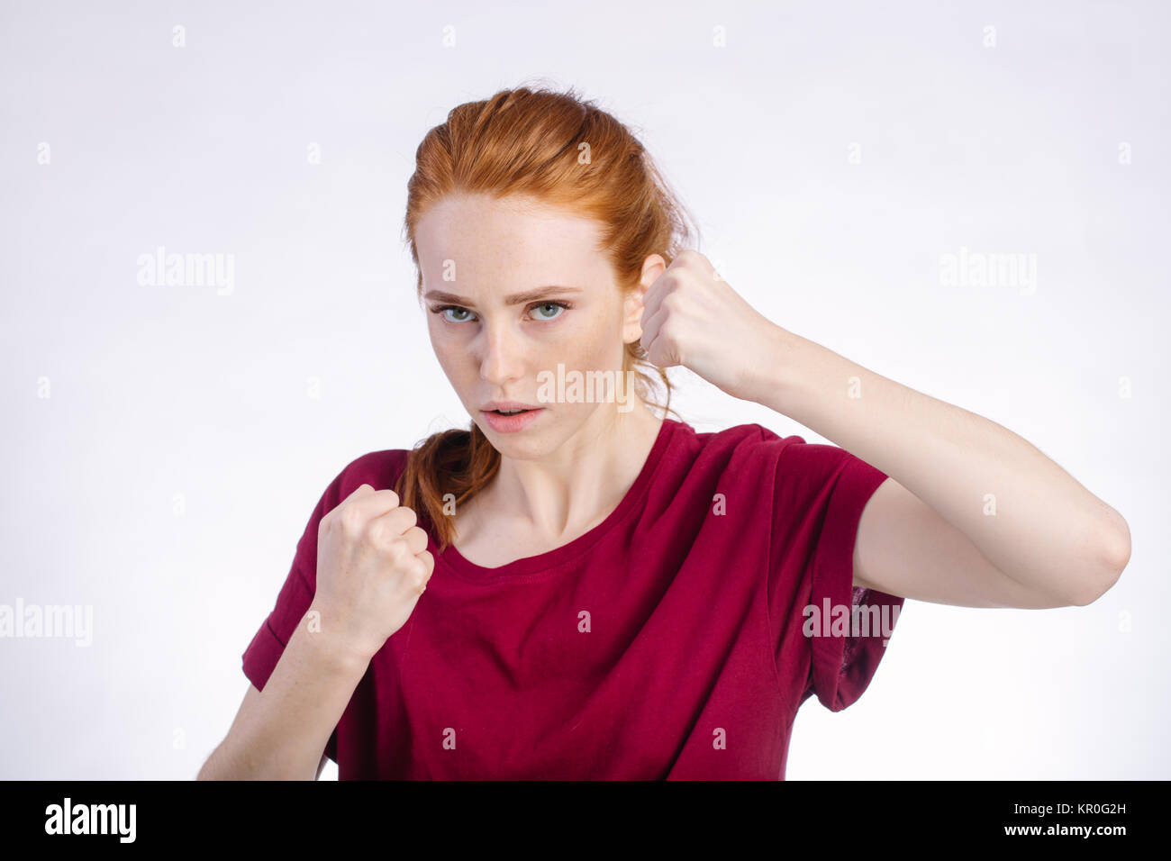 angry woman standing with raised knuckles on white background Stock ...